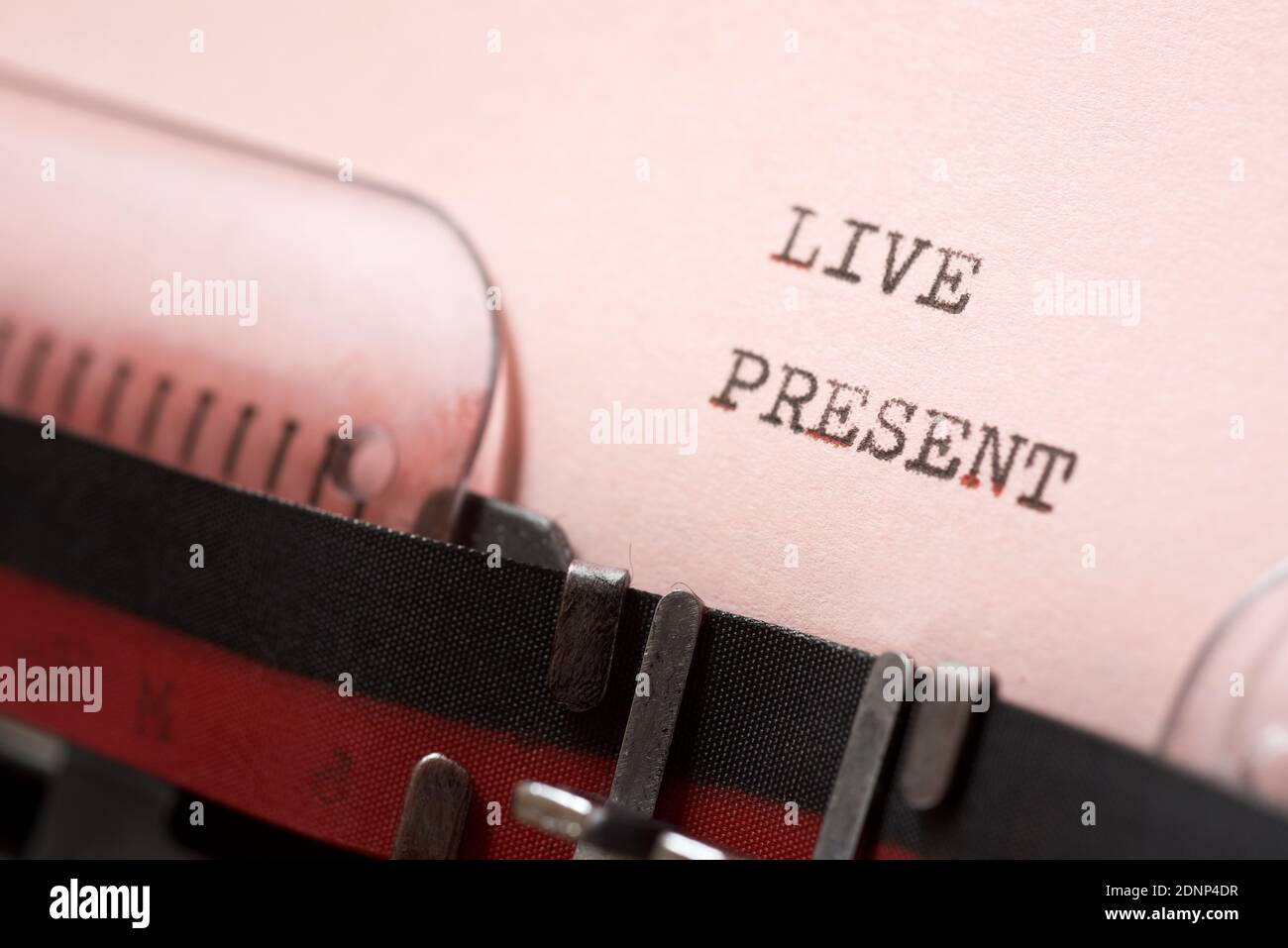 Live present phrase written with a typewriter Stock Photo - Alamy