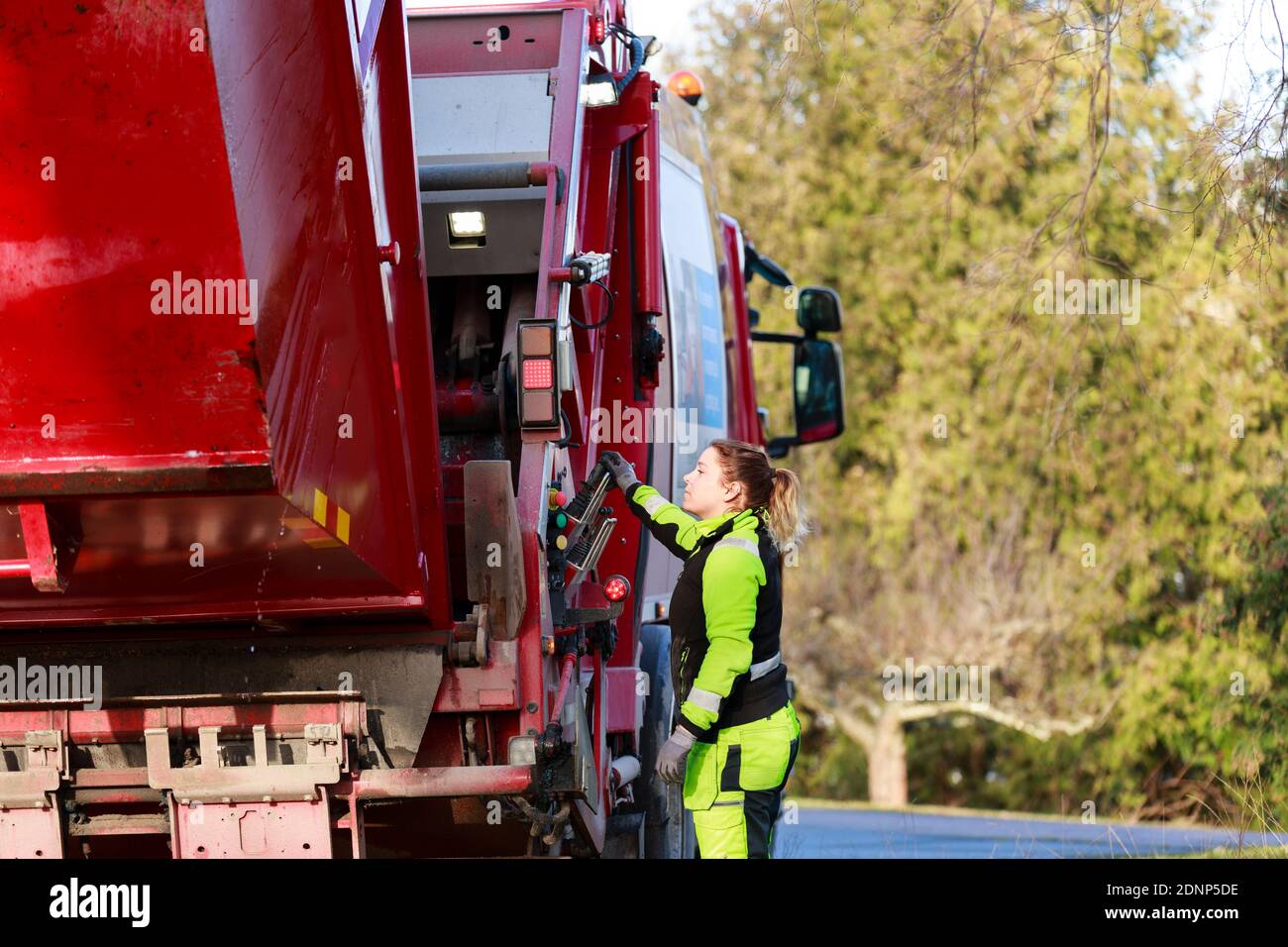 Woman operating garbage truck Stock Photo - Alamy