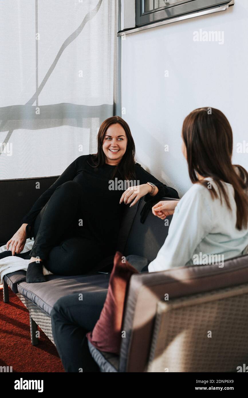 Two women friends talking sofa hi-res stock photography and images - Alamy