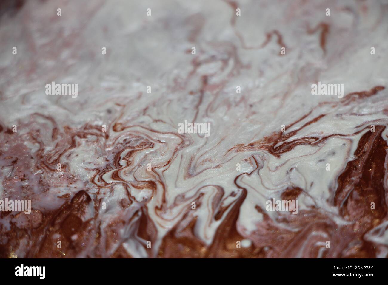 Acrylic paint diffusion texture of white and coral colors with marble texture and golden powder ...