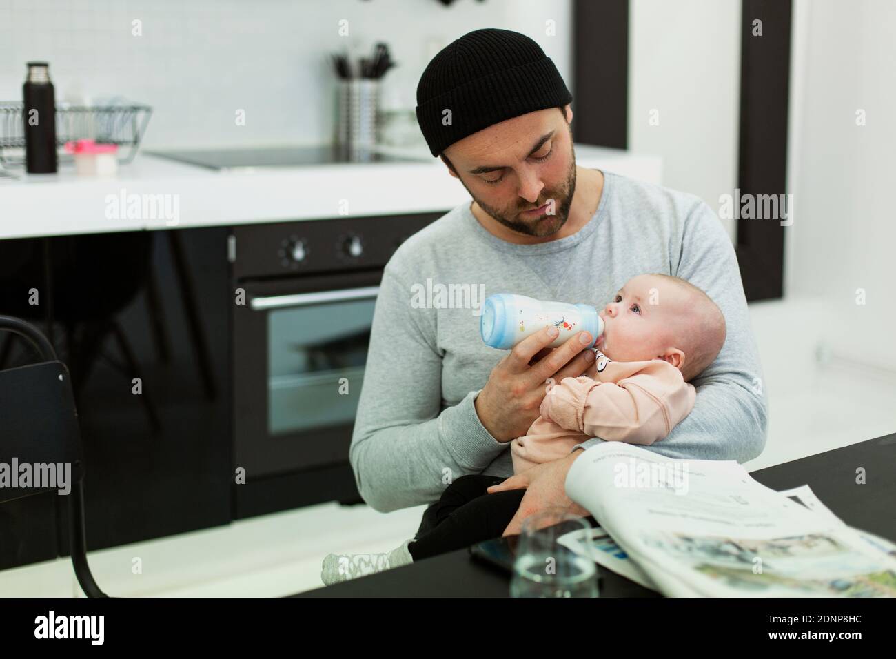 Father feeding baby Stock Photo - Alamy