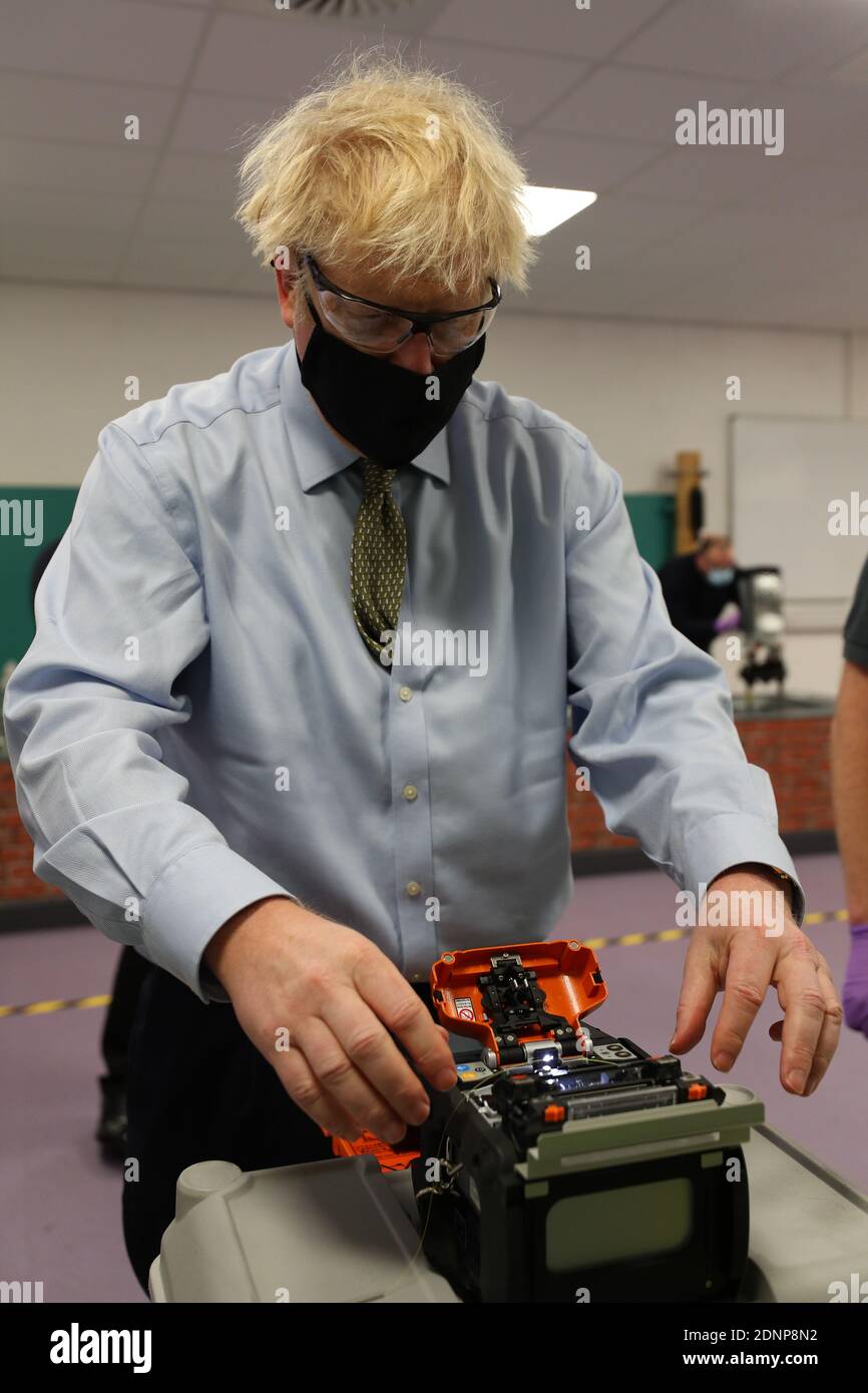 Prime Minister Boris Johnson tries his hand at cable splicing during a ...