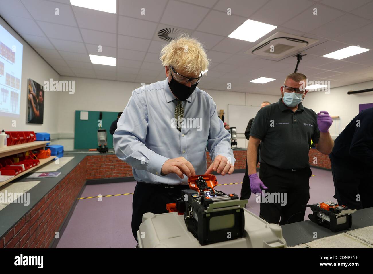 Prime Minister Boris Johnson tries his hand at cable splicing with ...