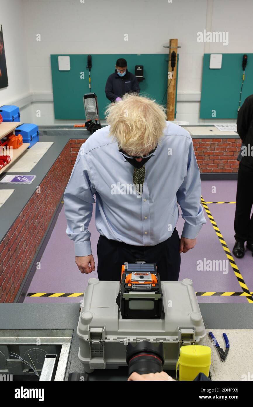 Prime Minister Boris Johnson looks at cable splicing equipment during a ...