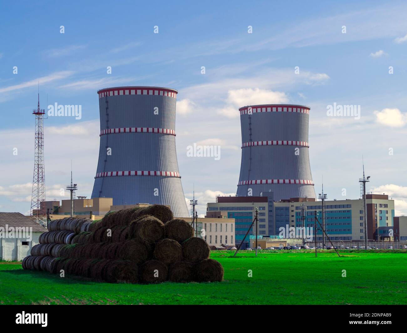 Belarusian Nuclear power plant. Green field and haystacks on the ...