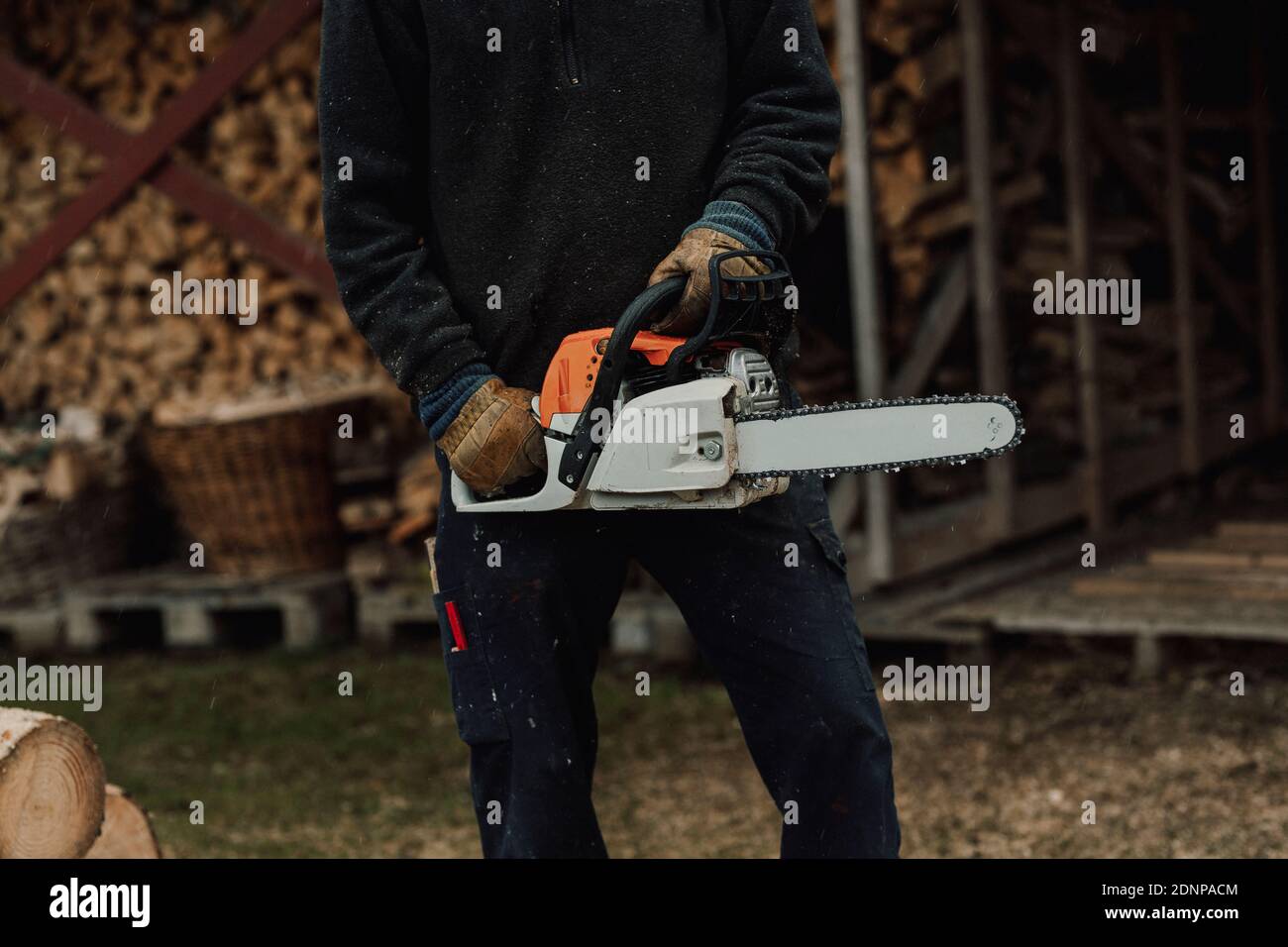 Man holding chainsaw Stock Photo - Alamy