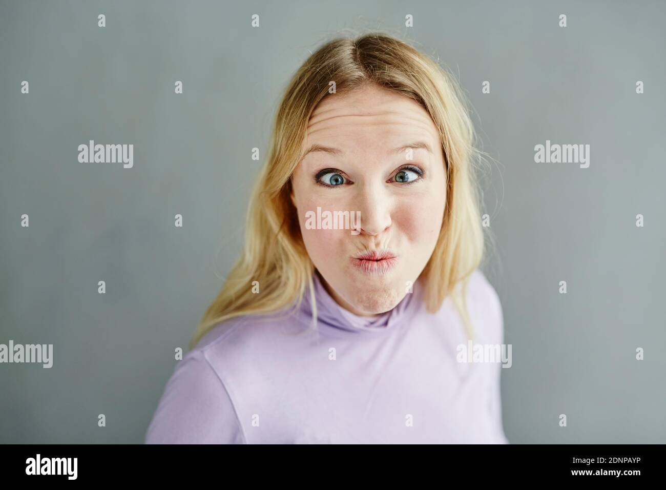 Portrait of woman making funny face Stock Photo - Alamy