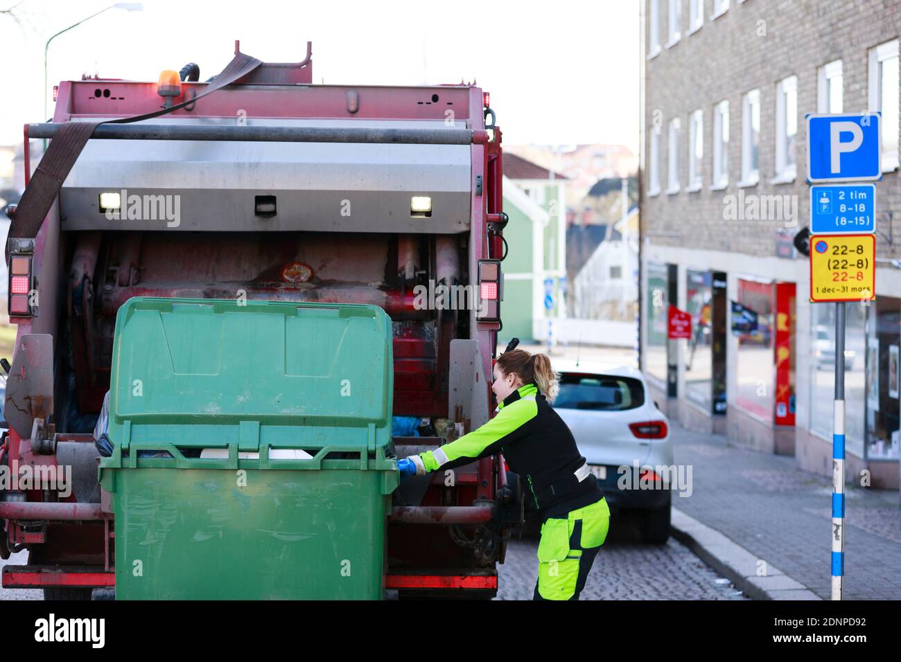 Woman operating garbage truck Stock Photo - Alamy
