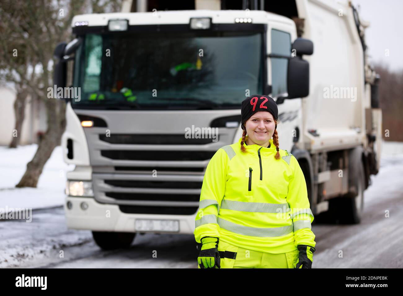 Woman standing in front of garbage truck Stock Photo - Alamy