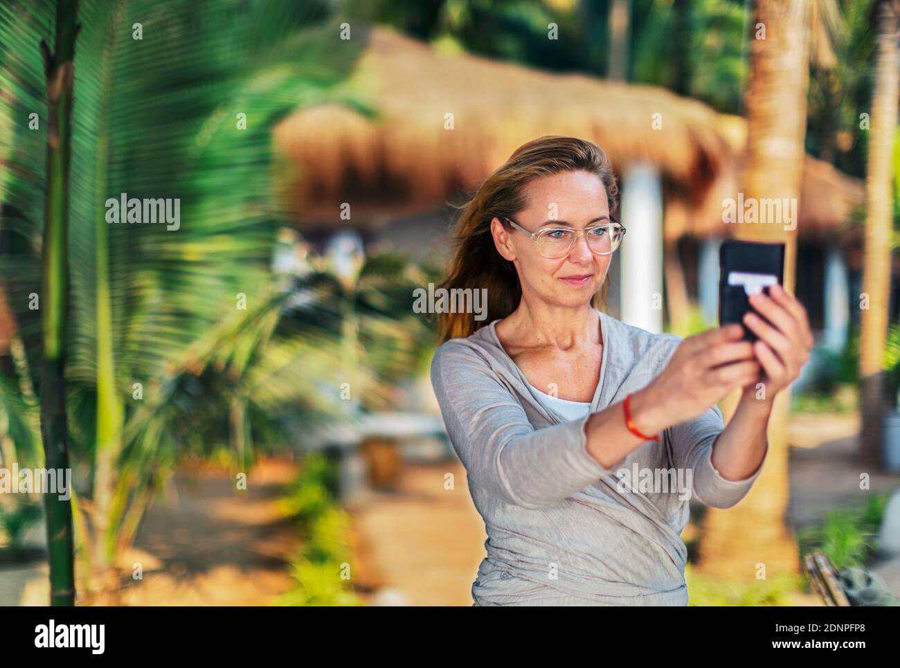 Woman photographing with cell phone Stock Photo - Alamy