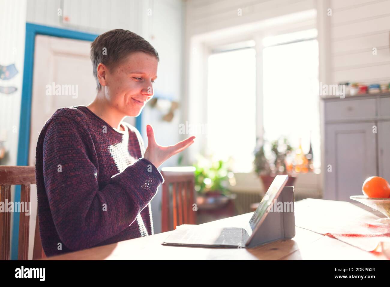Woman having sign language conversation via video call on computer ...