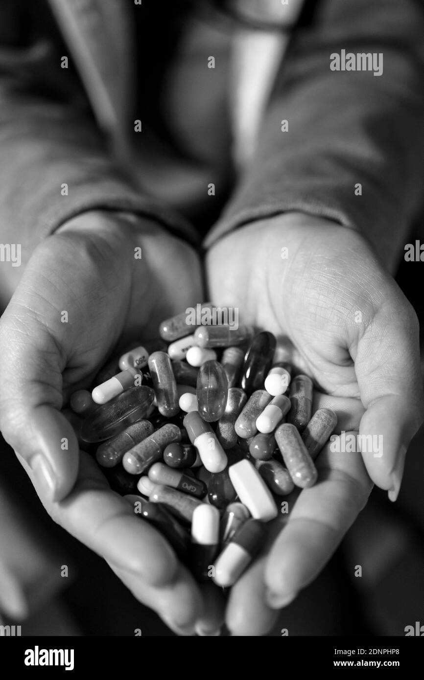 Hand holding capsules Black and White Stock Photos & Images - Alamy