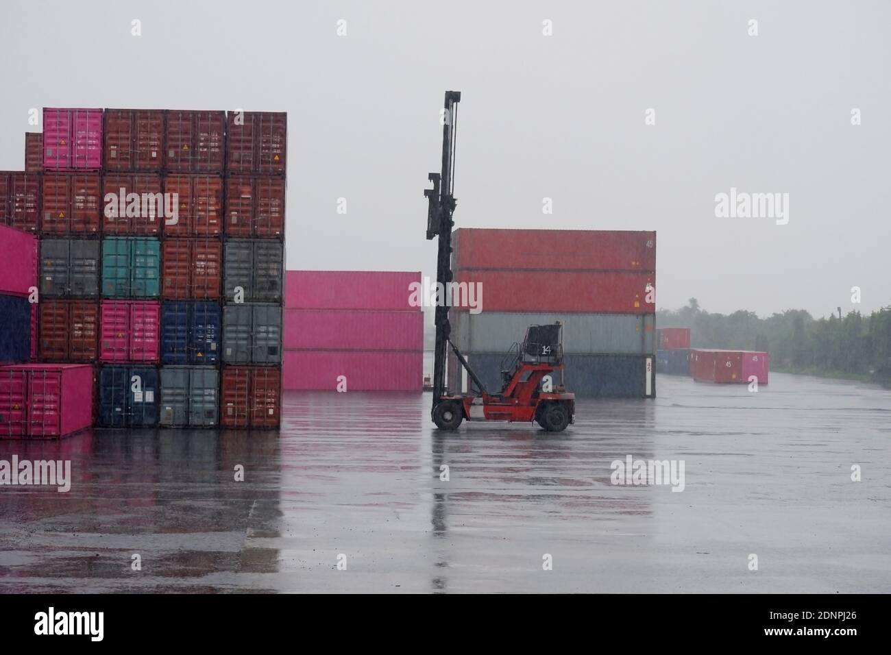 Container truck working in the rain Stock Photo - Alamy
