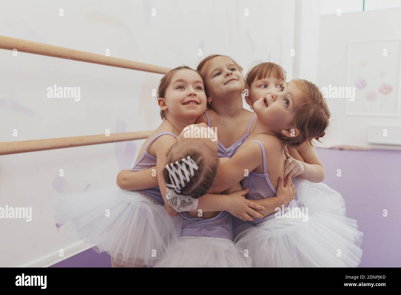 Adorable little girls hugging each other, enjoying dancing at ballet ...