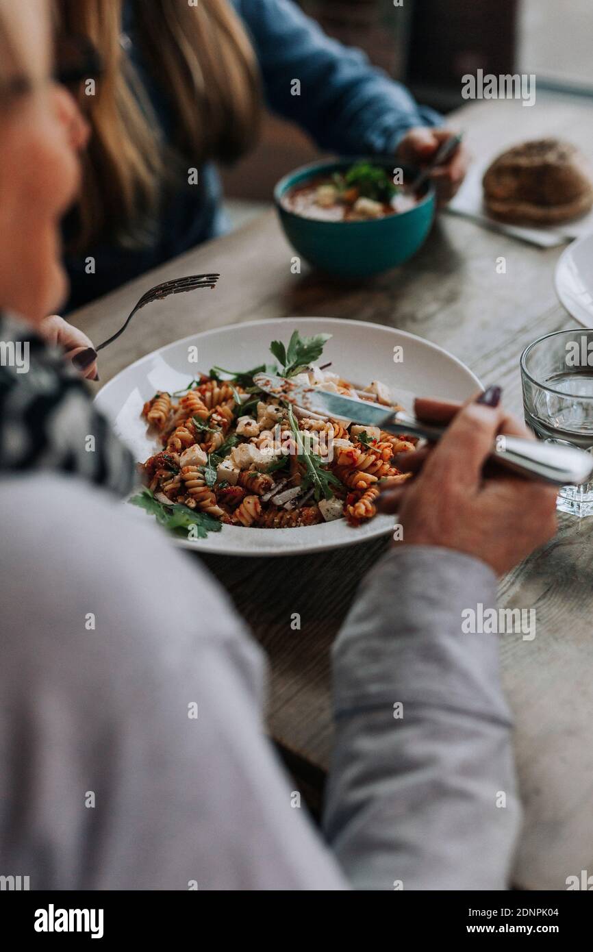 Woman eating pasta Stock Photo - Alamy