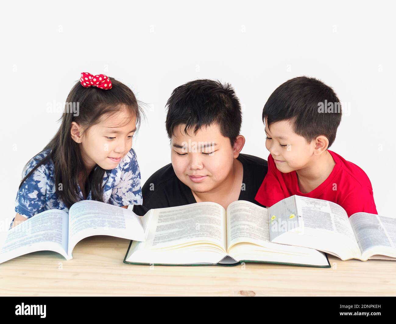 Asian siblings reading book hi-res stock photography and images - Alamy