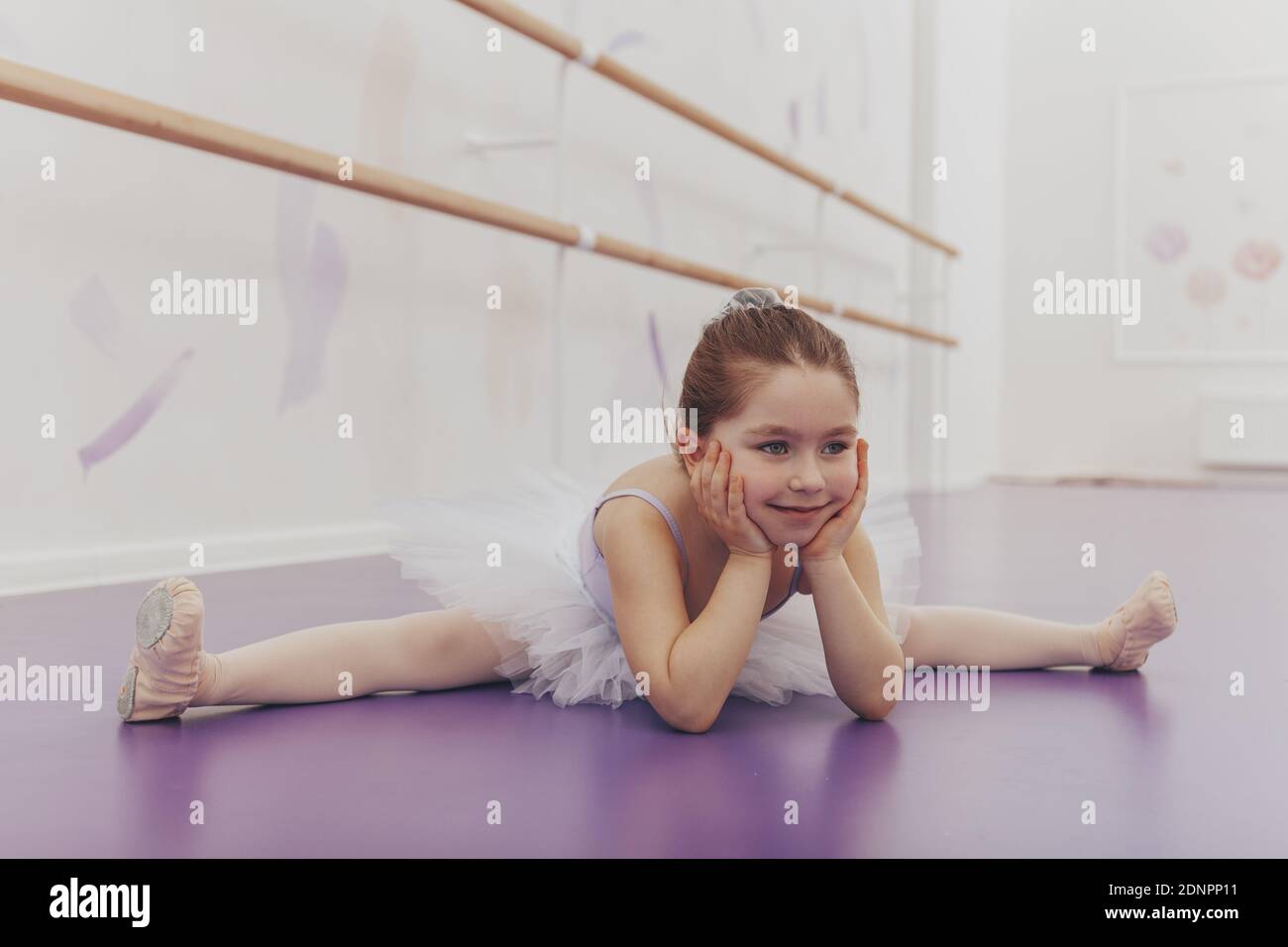 CUte happy little ballerina doing splits at dance school. Adorable ...