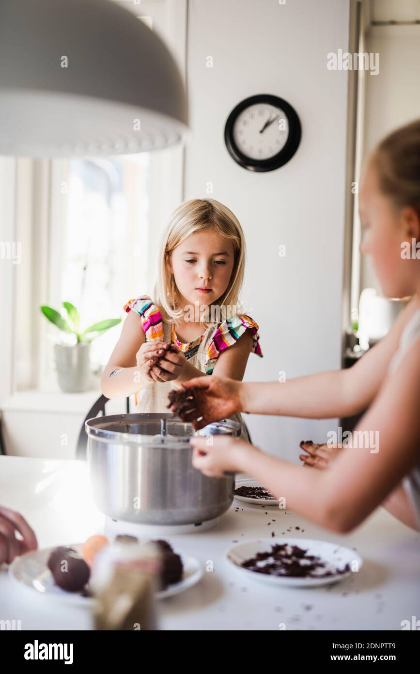 Girls making food in kitchen Stock Photo - Alamy