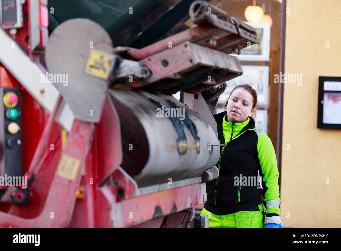 Woman operating garbage truck Stock Photo - Alamy