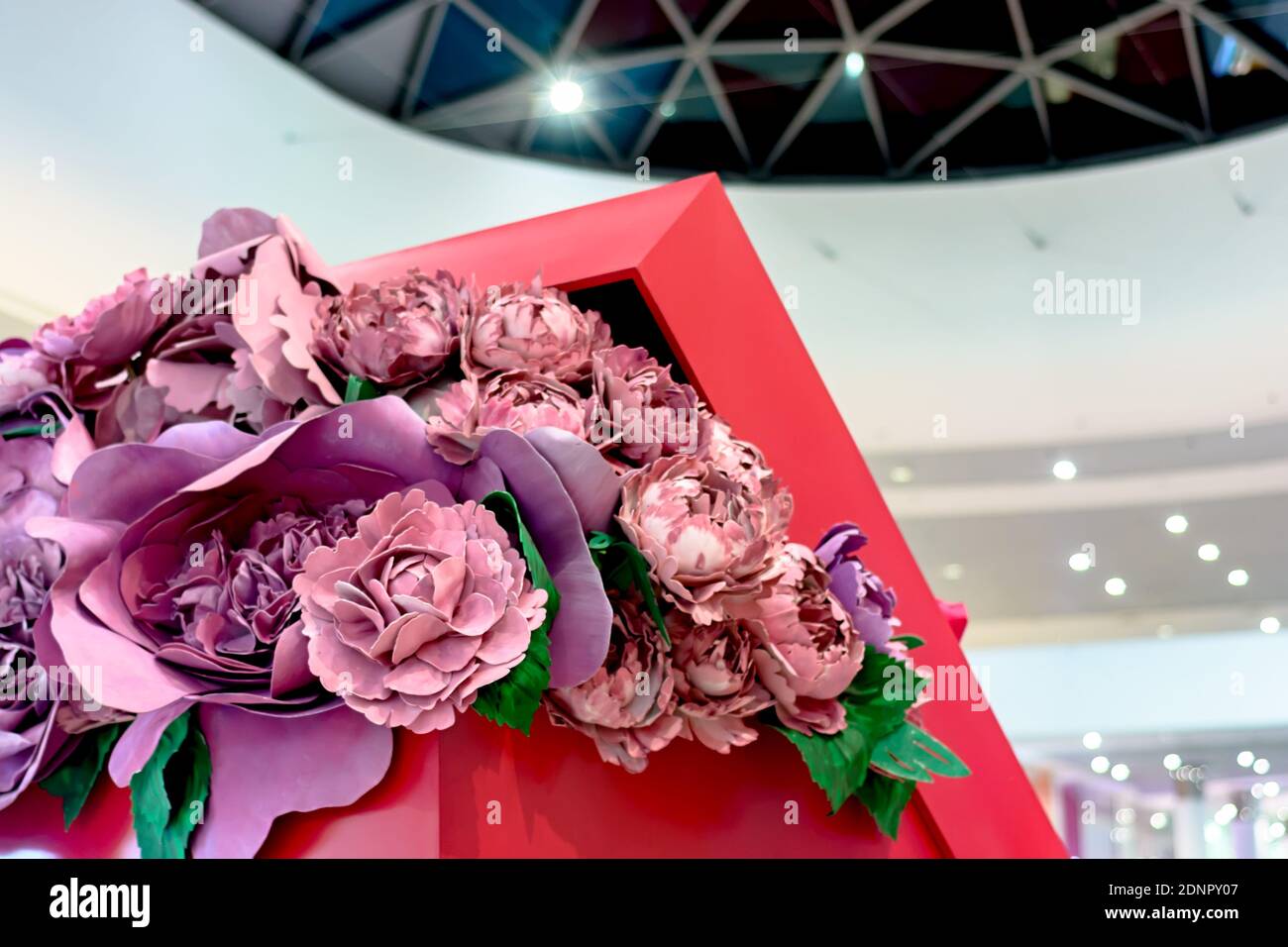Red gift box with red flowers Stock Photo - Alamy