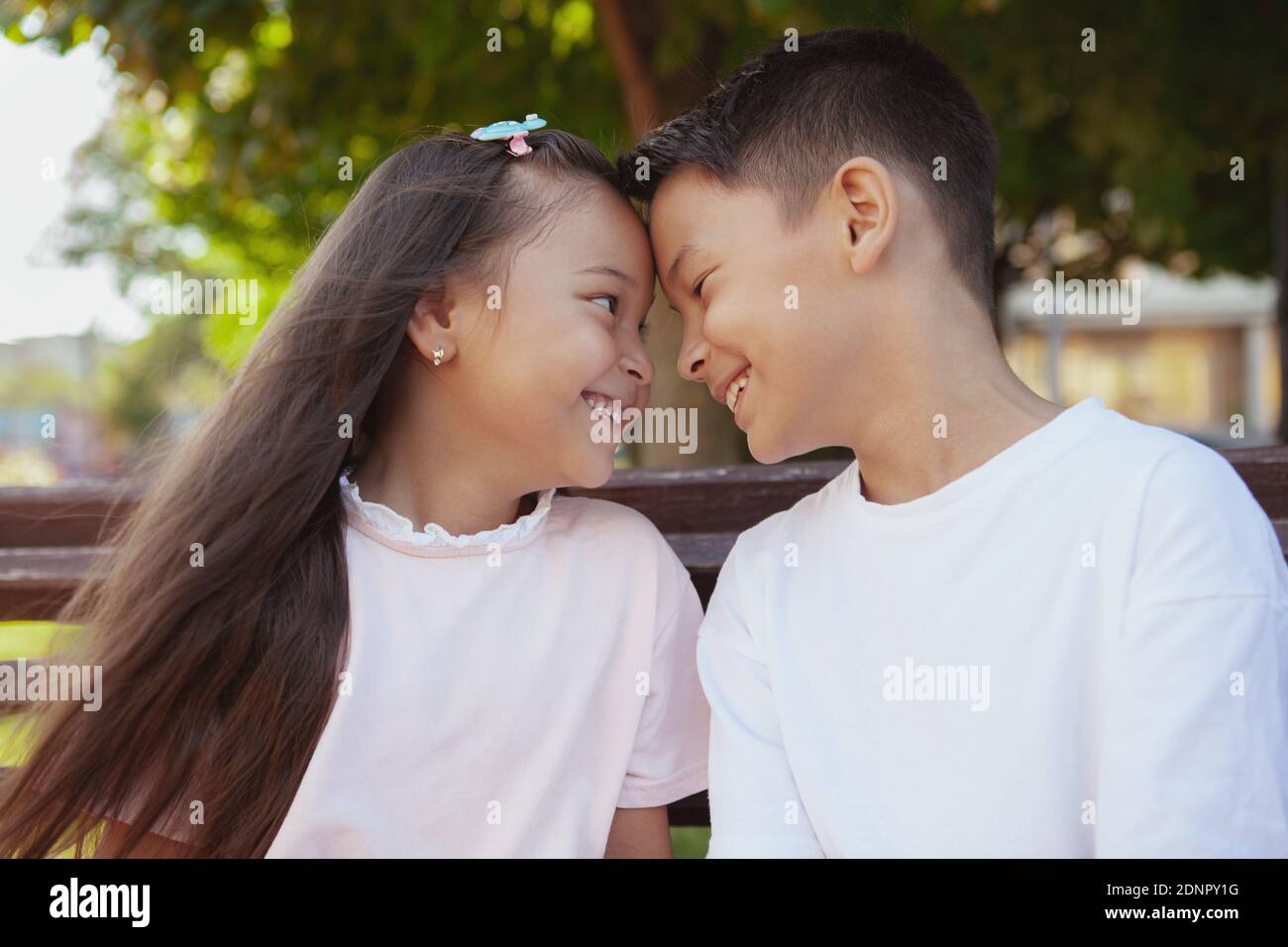 Close up of happy cute little kids smiling, touching with their ...