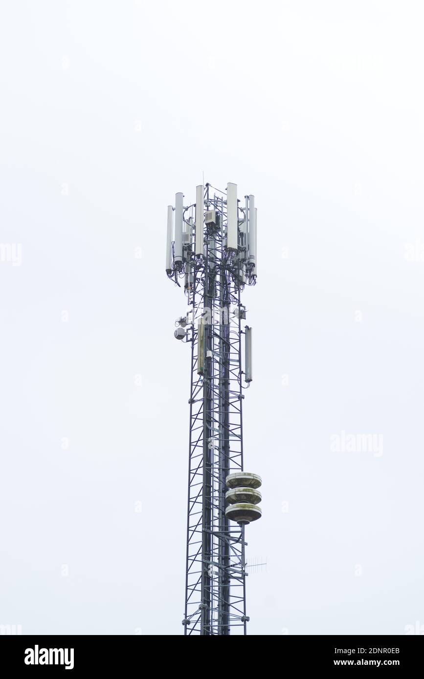 high communications mast with several antennas for cellular phone ...
