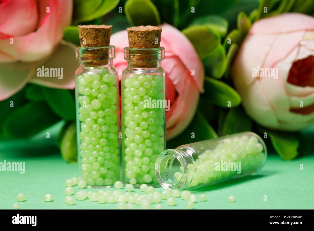 glass bottles with green granules with roses. homeopathic remedies ...