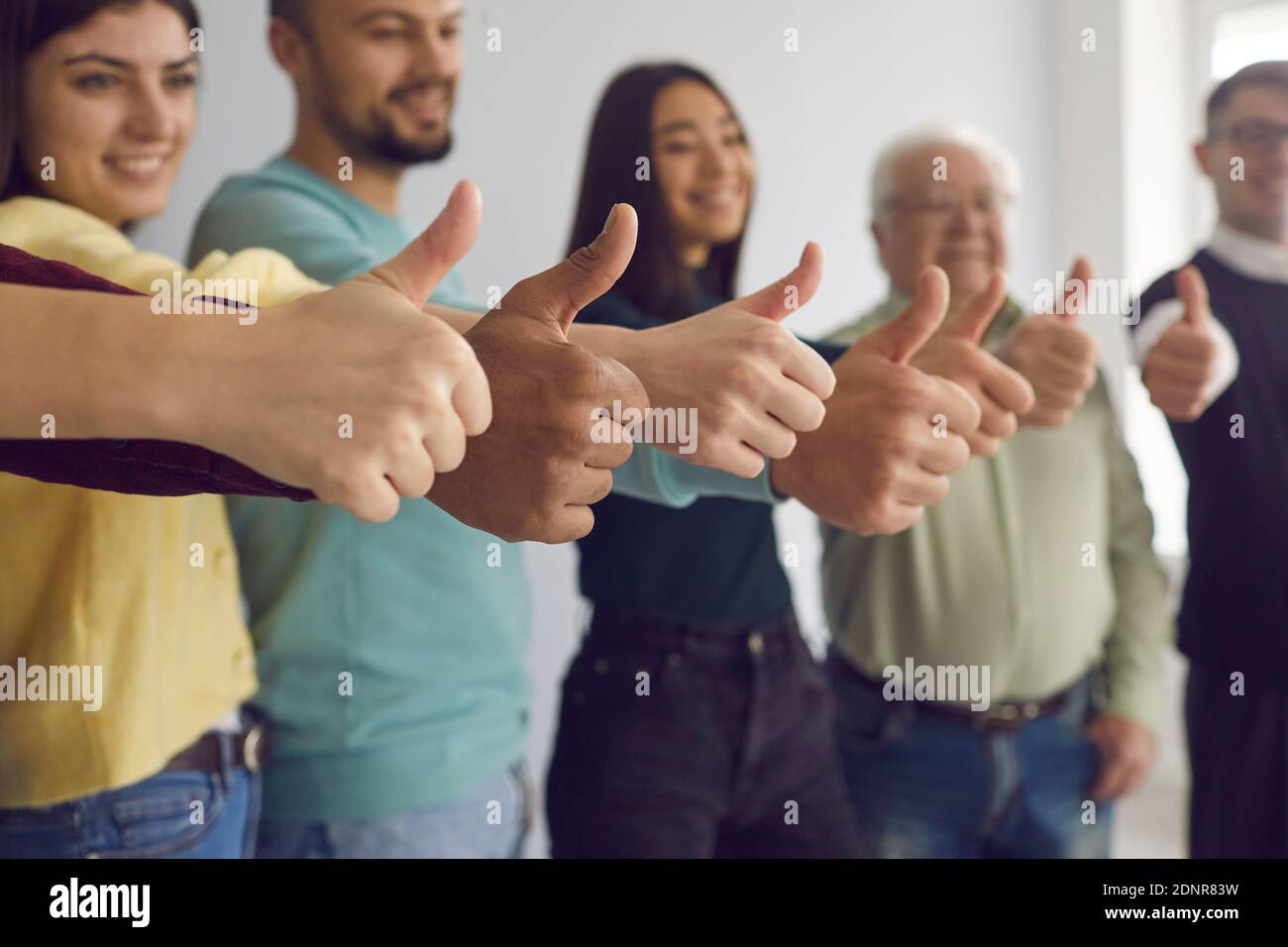 Diverse people of different age and race standing in row and showing ...