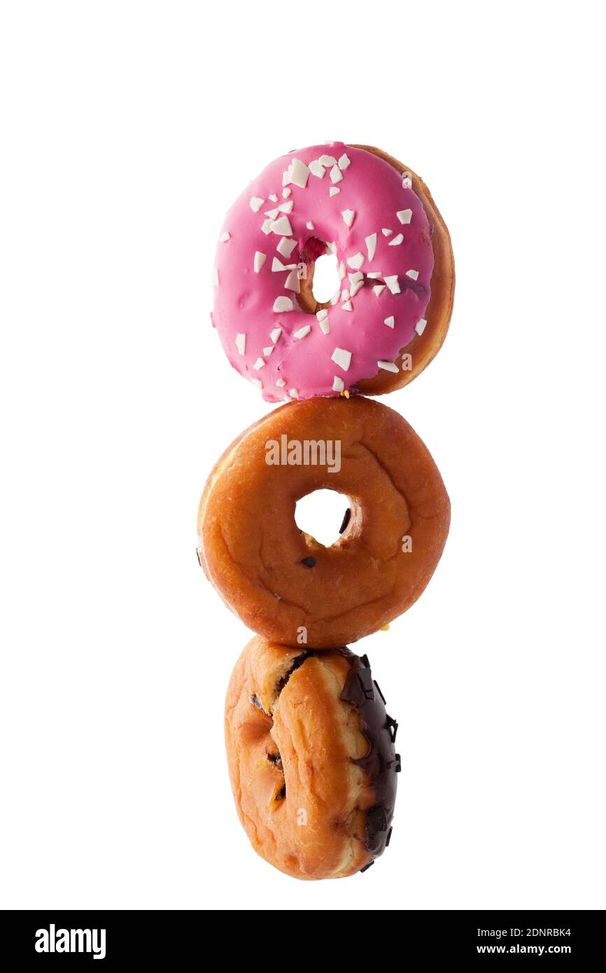 Stack of donuts hanging in the air isolated on white background Stock ...