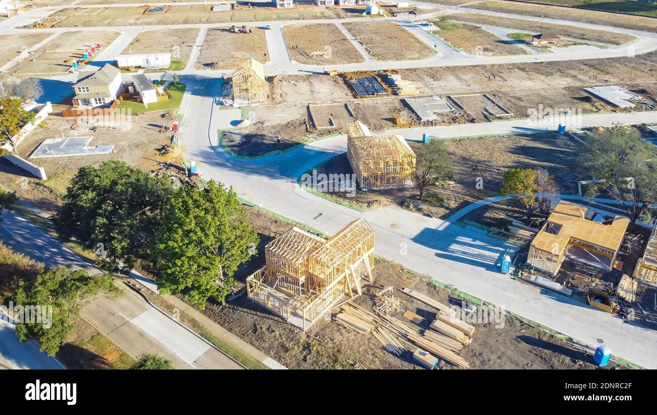 Multiple wooden houses under construction at master planned community ...