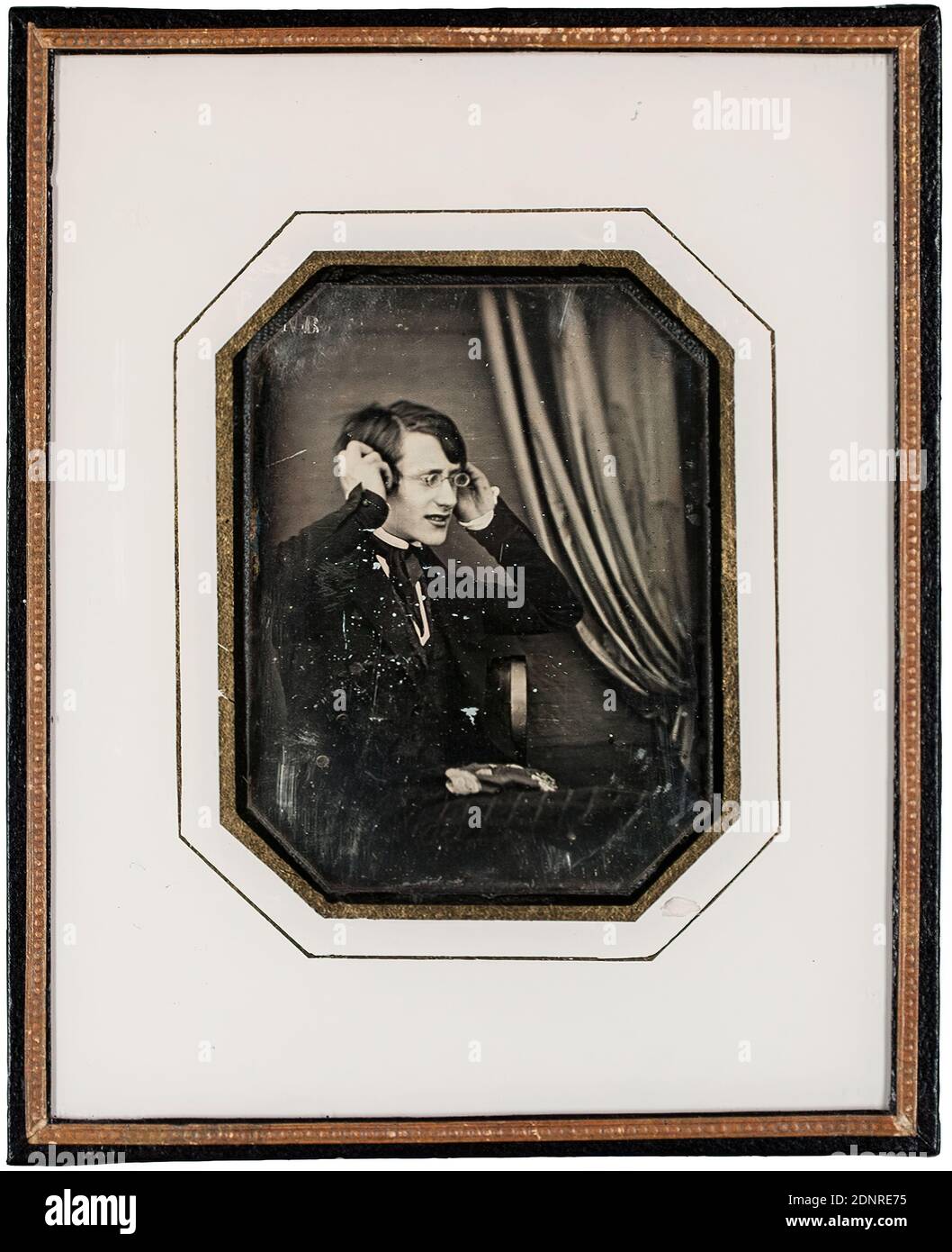 young man putting on his glasses, daguerreotype, image size : height: 6 ...