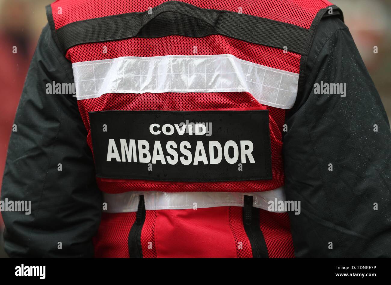 A view of the back of the vest of a Covid ambassador seen in Chichester ...
