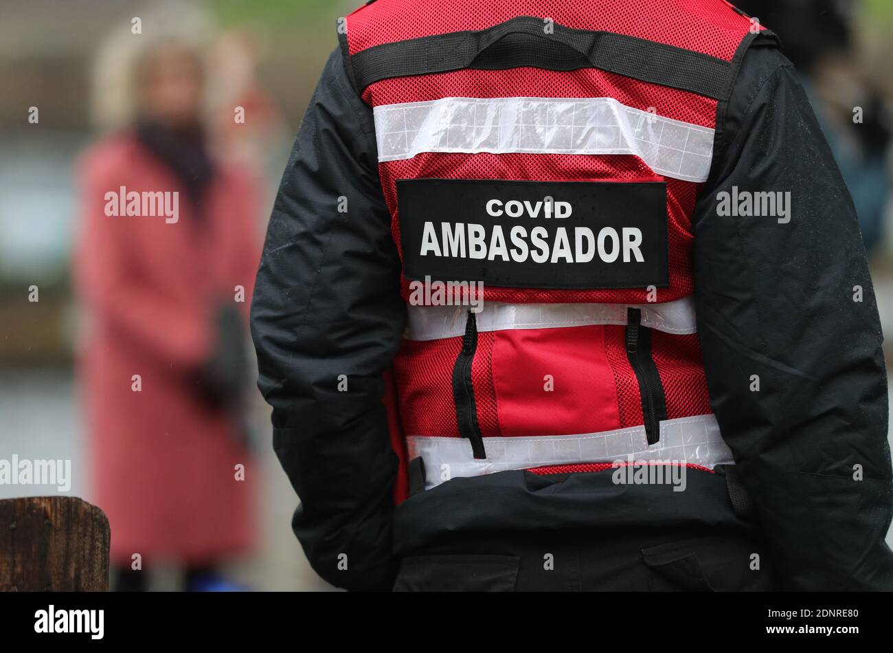 A view of the back of the vest of a Covid ambassador seen in Chichester ...