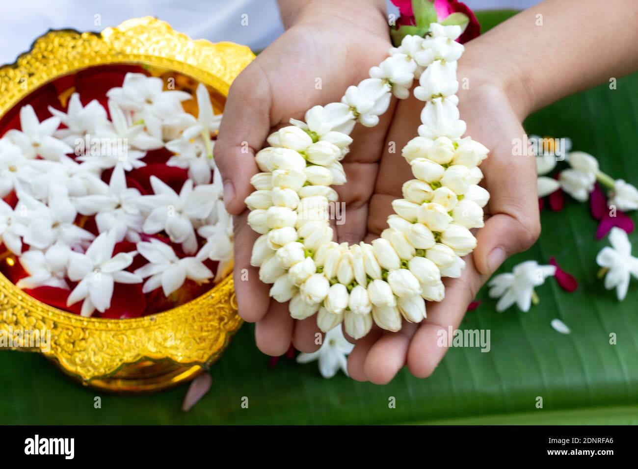 Human hand holding garland of flower hi-res stock photography and ...