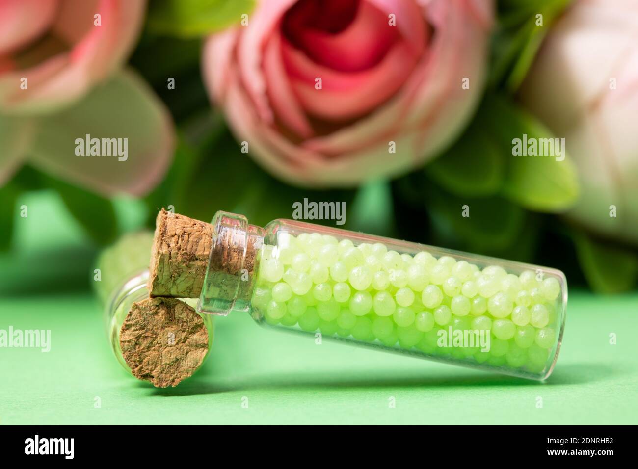 glass bottles with green granules with roses. homeopathic remedies ...