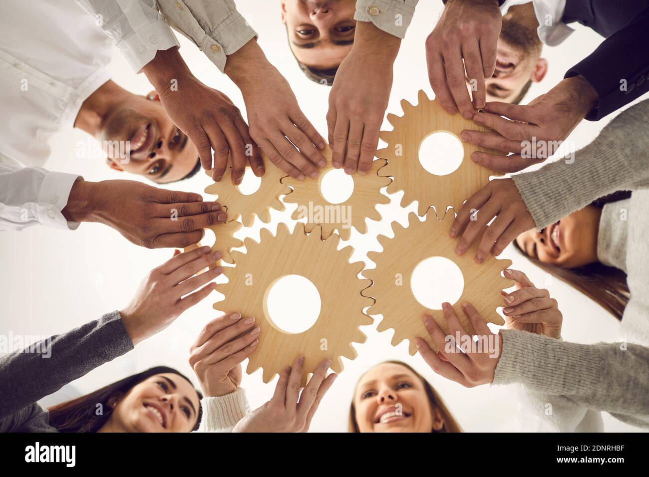 Team of people joining gears as metaphor for effective teamwork and ...