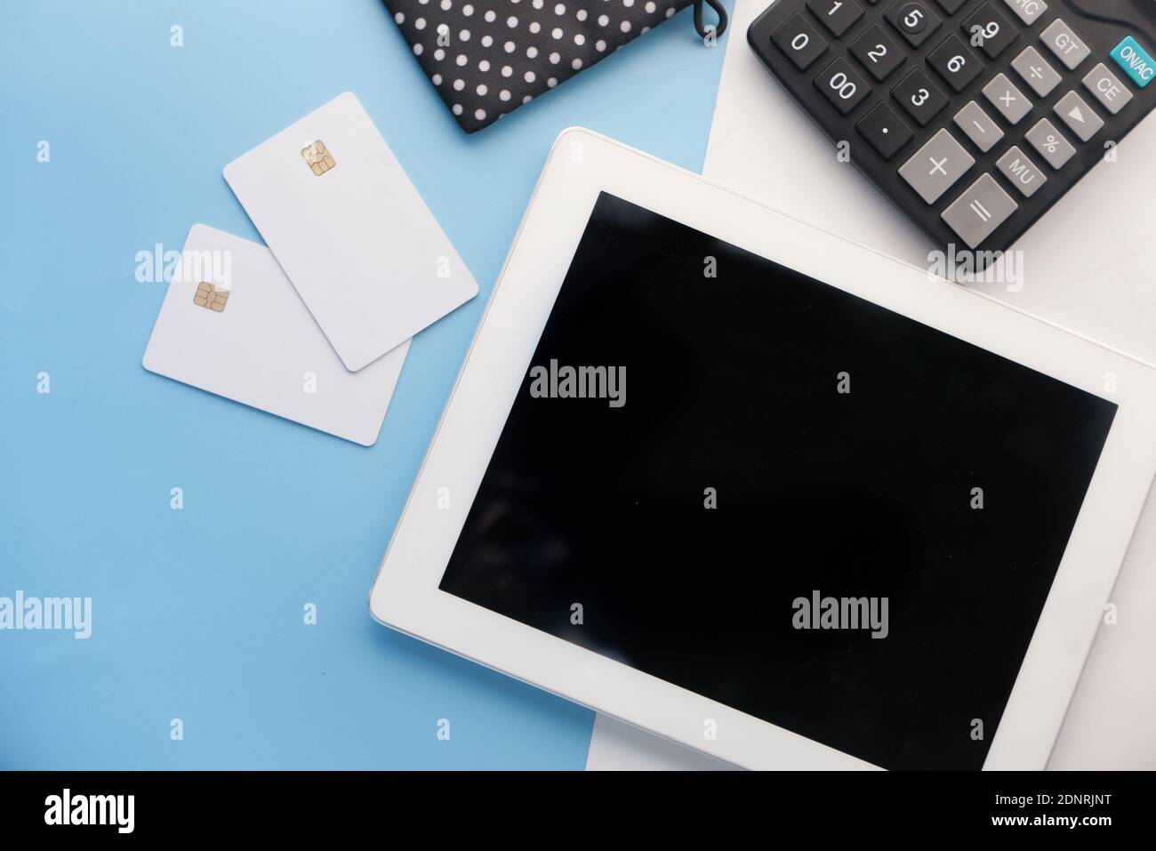 top view of digital tablet, credit cards with office suppliers on table ...