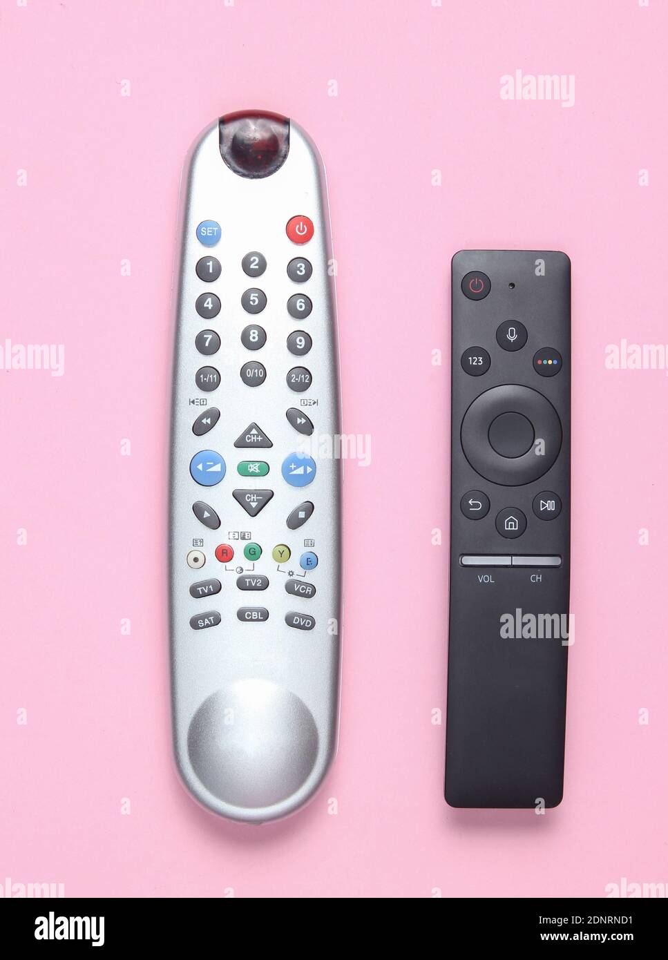 Two modern tv remote on a pink pastel background. Top view, minimalism ...