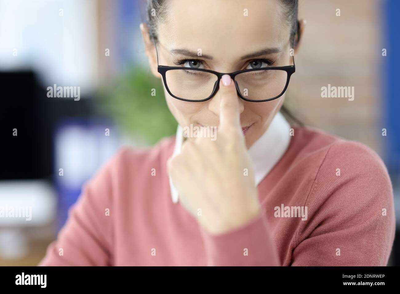 Young woman hand adjusting glasses for vision Stock Photo - Alamy