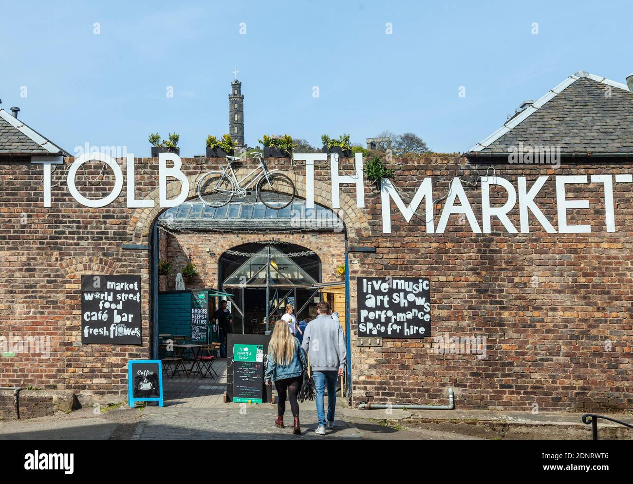 A young couple going into the Old Tolbooth Market,a street food and ...