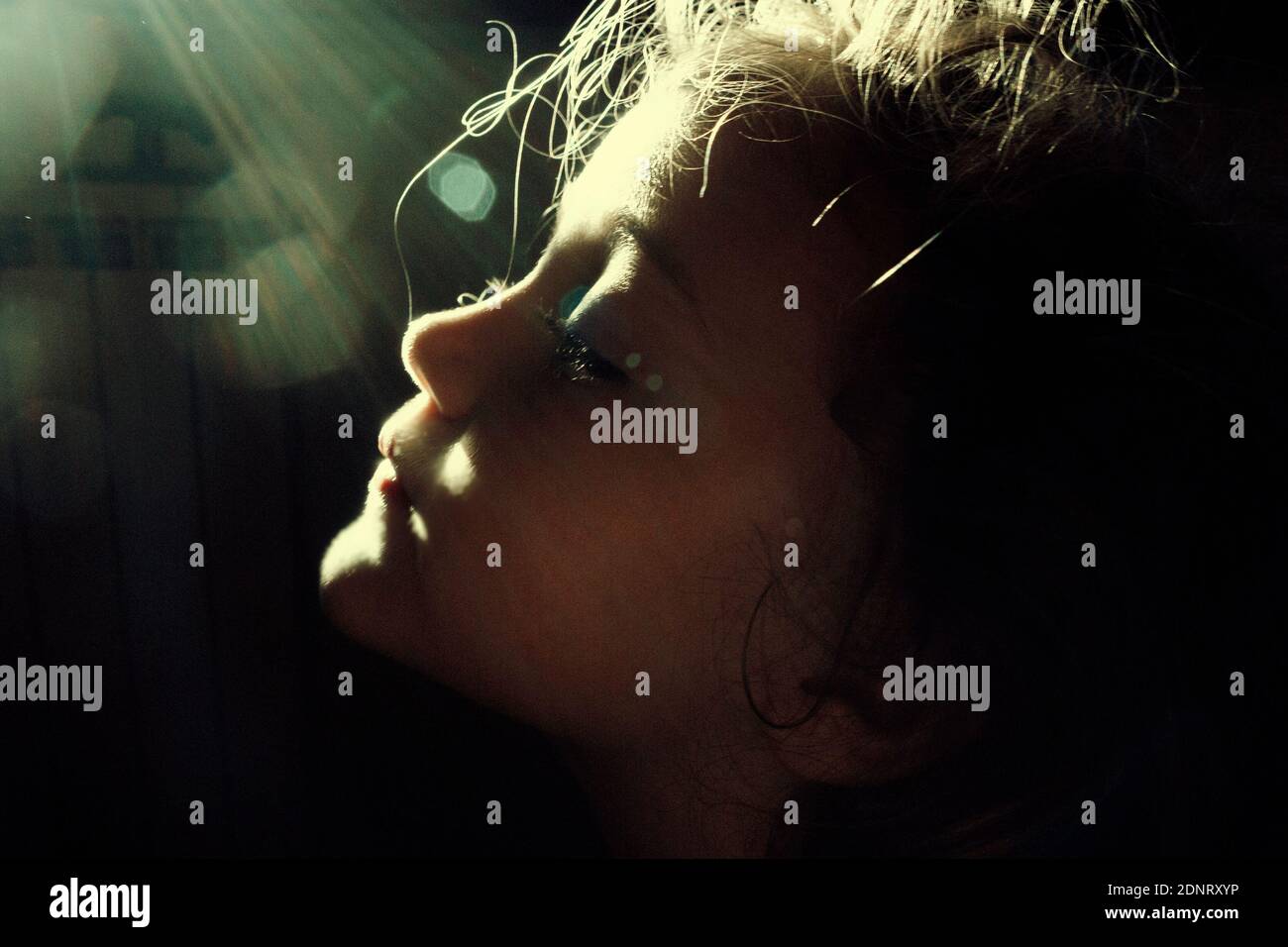 Portrait of a girl standing in sunlight outdoors, Italy Stock Photo - Alamy