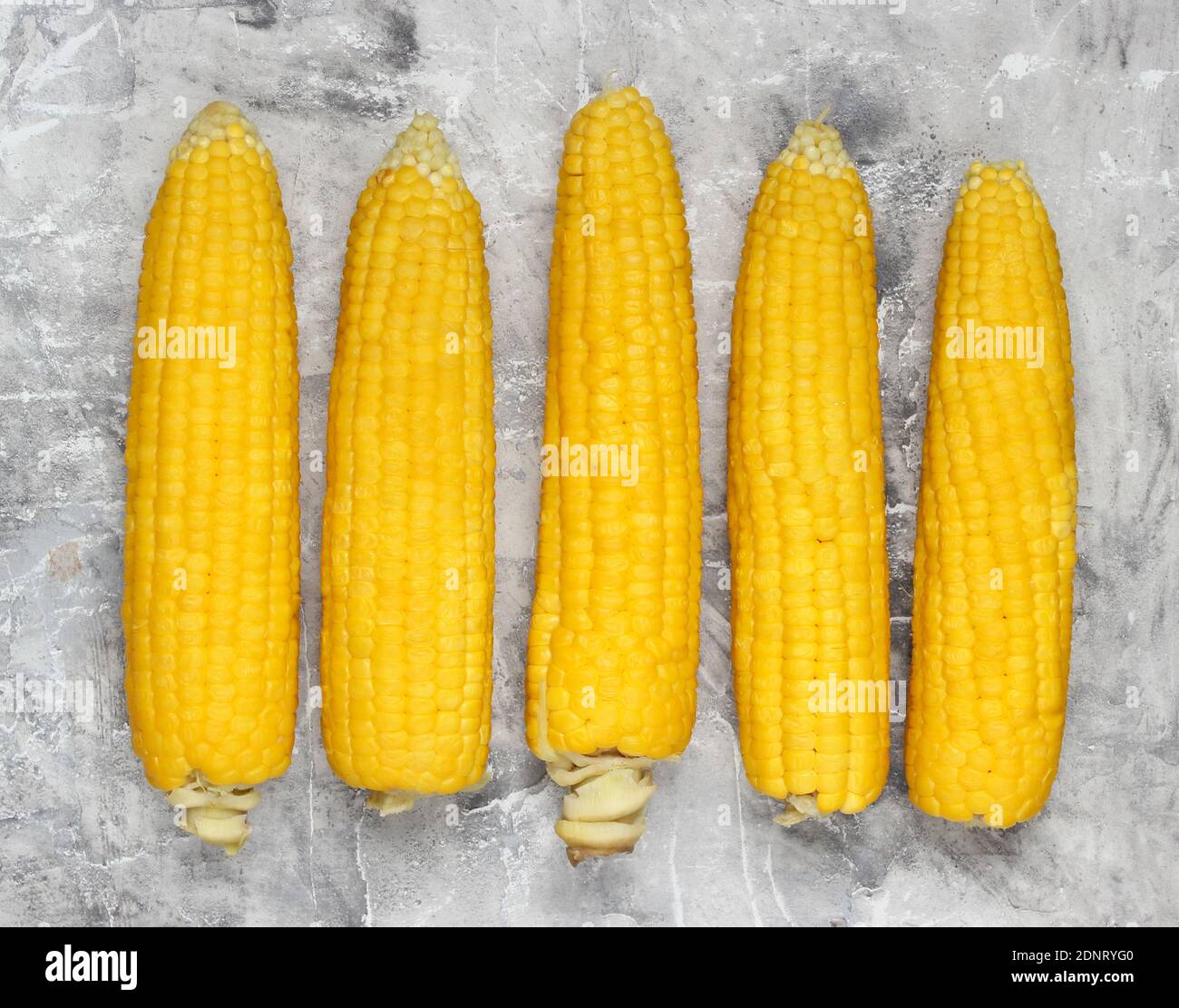 Ripe boiled corn on a gray concrete table, top view Stock Photo - Alamy