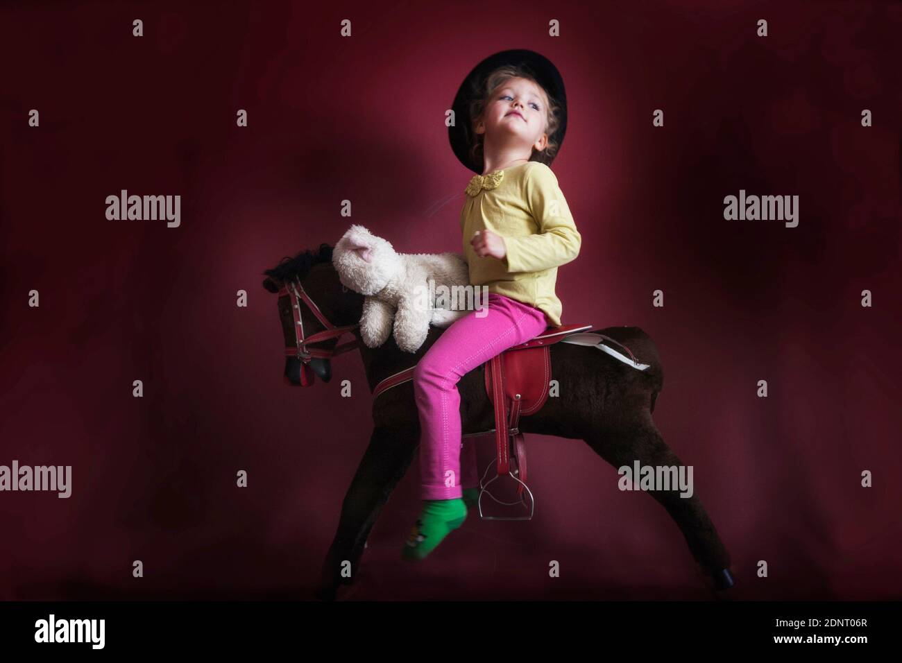 Bear sitting on toy horse hi-res stock photography and images - Alamy