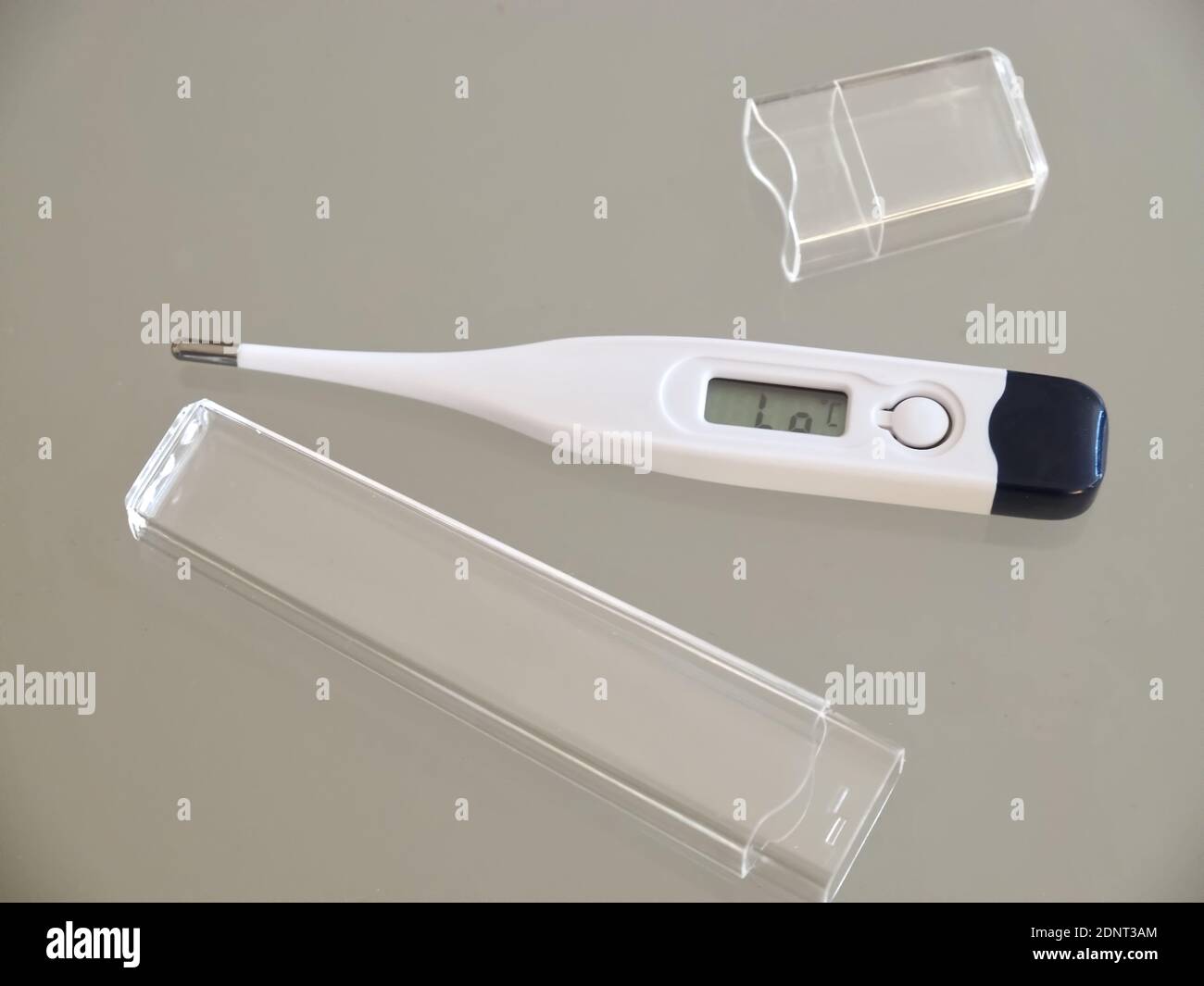 Medical thermometer to measure fever on a glass background Stock Photo ...