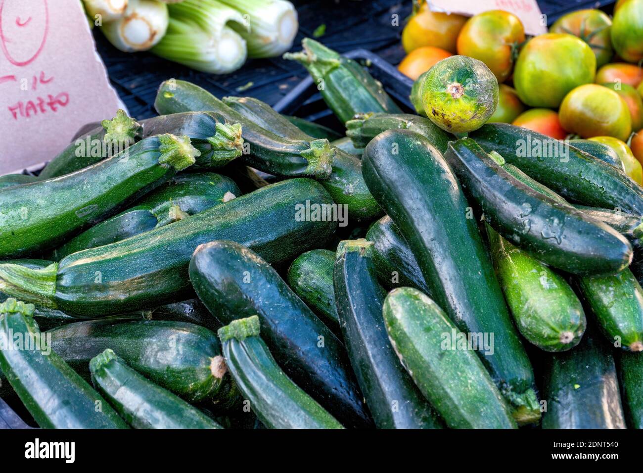 A group of green courgettes at a street market in the city. Perfect ...