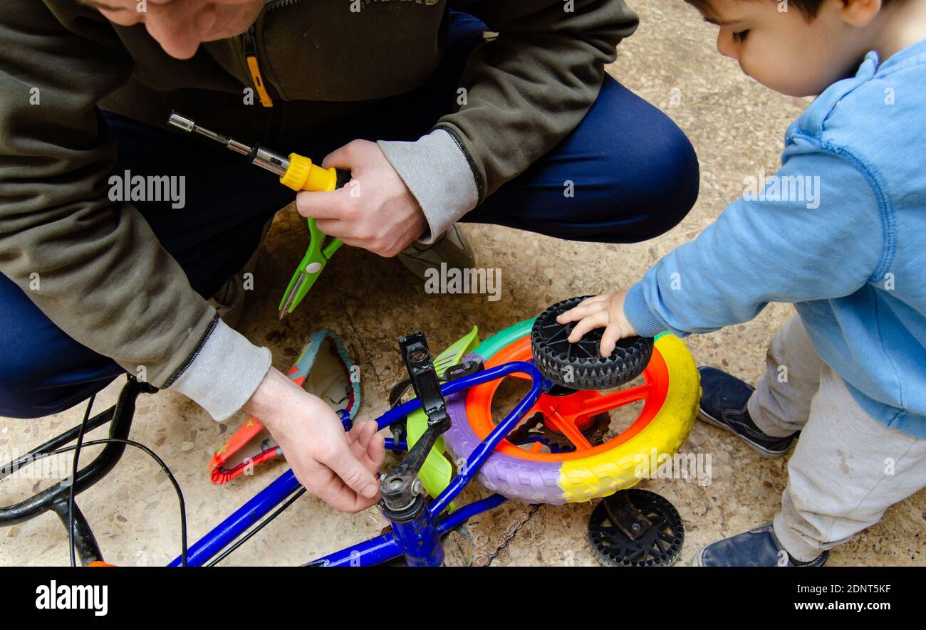 Boys repairing bicycle hi-res stock photography and images - Alamy