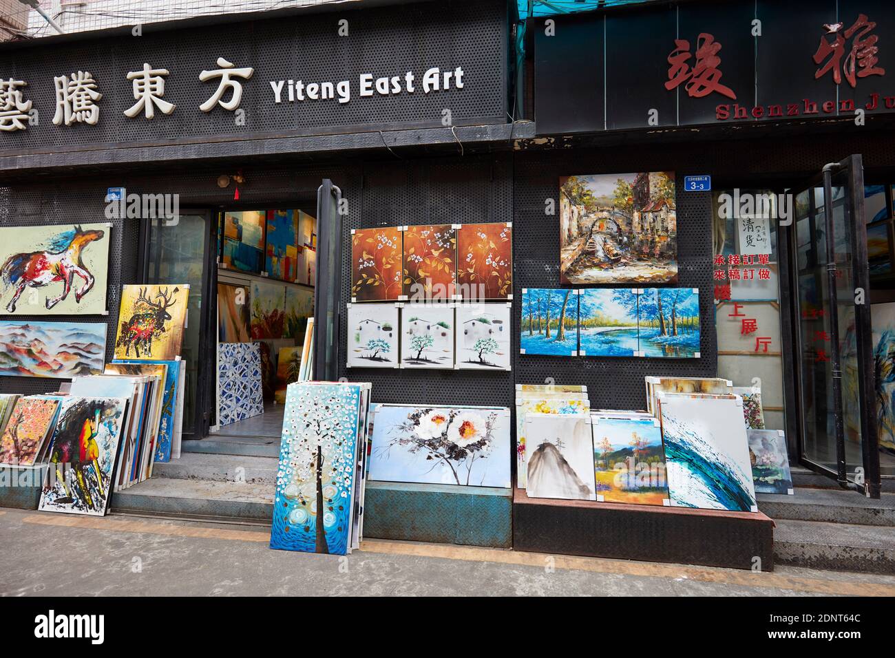 Local art gallery with paintings displayed outside. Dafen Oil Painting ...