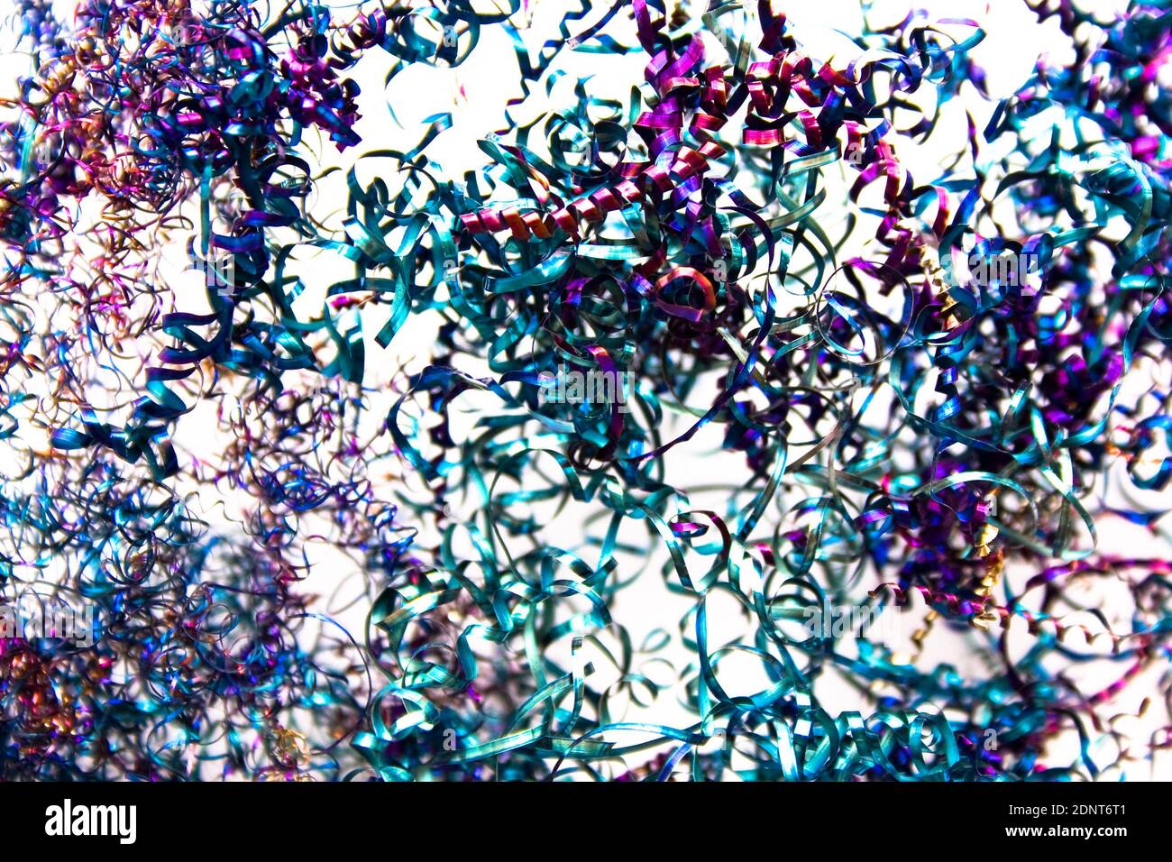 Multi-colored metal shavings. Twisted colorful metal chips (a waste ...