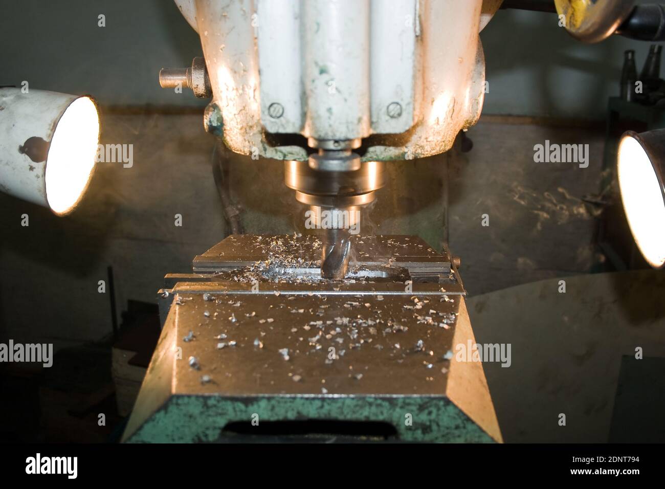 Milling a metal part. On an old vertically milling machine, a metal ...