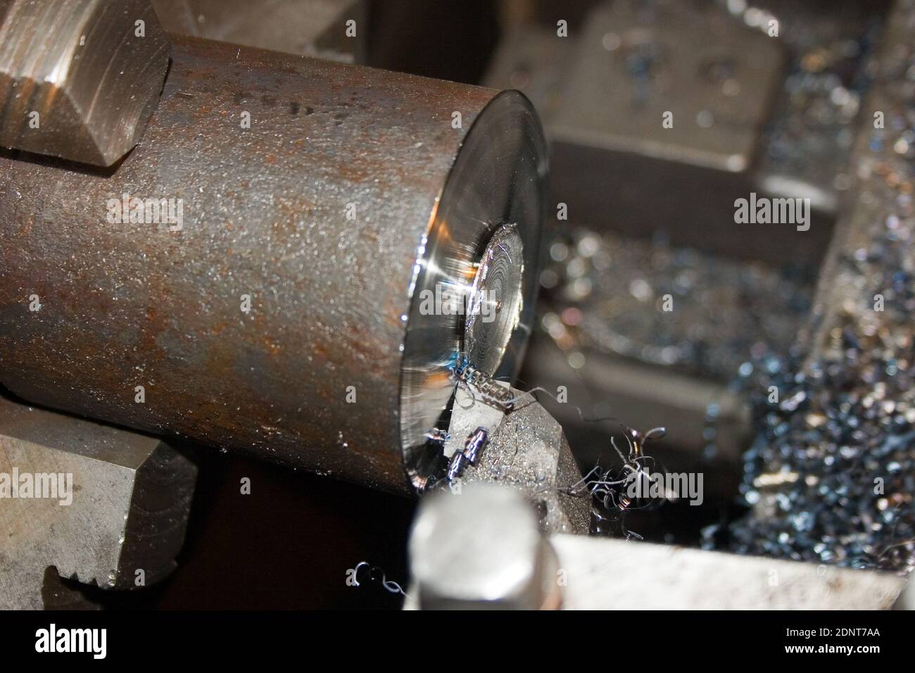 Turning operation. Cutting the end of a metal bar on a lathe. Close-up ...